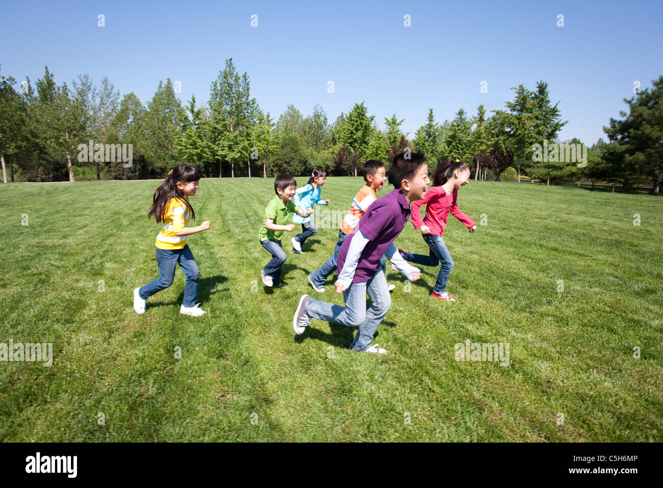 Children Running Across Field Stock Photo - Alamy