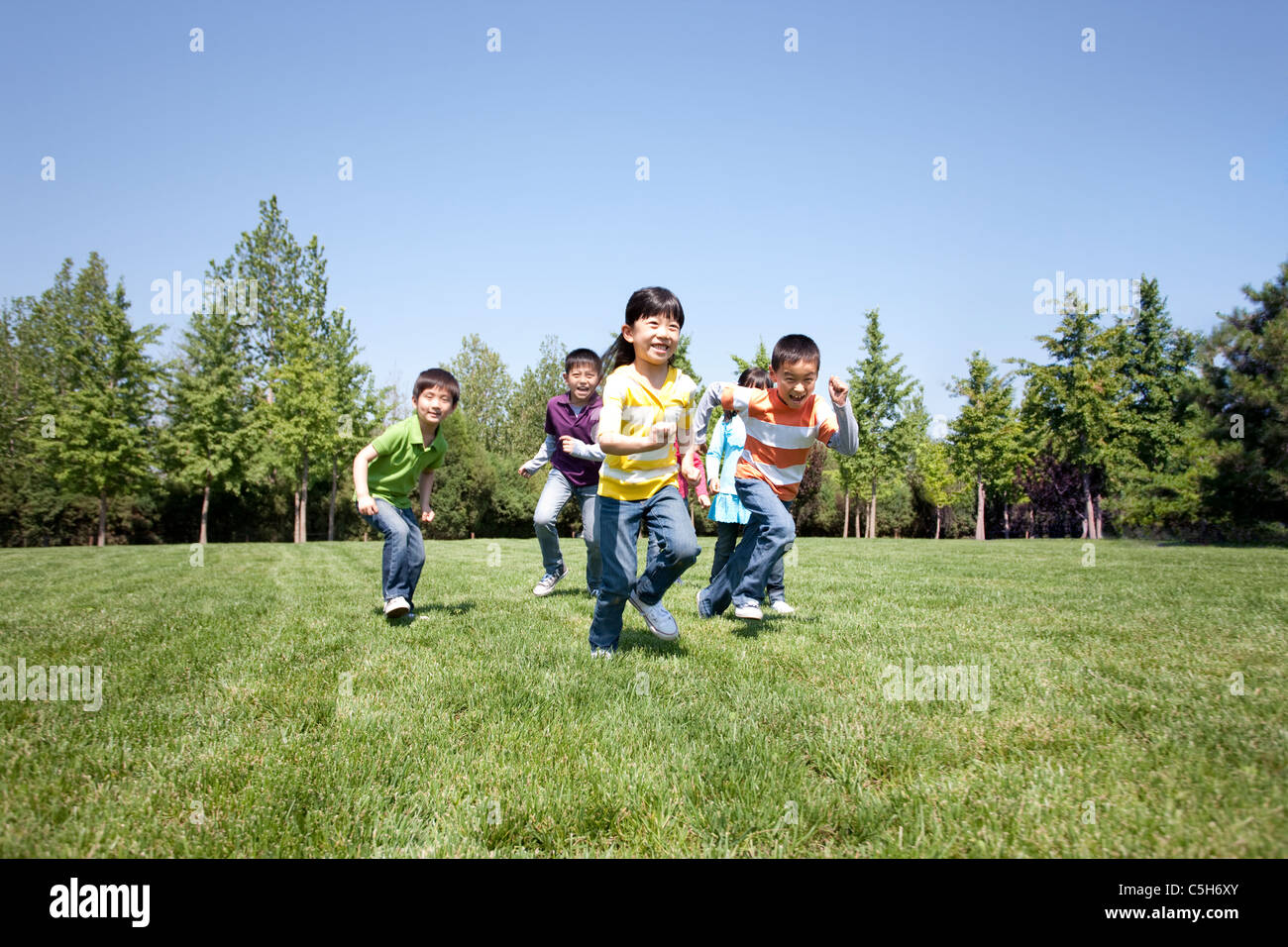 Children Running Across Field Stock Photo - Alamy