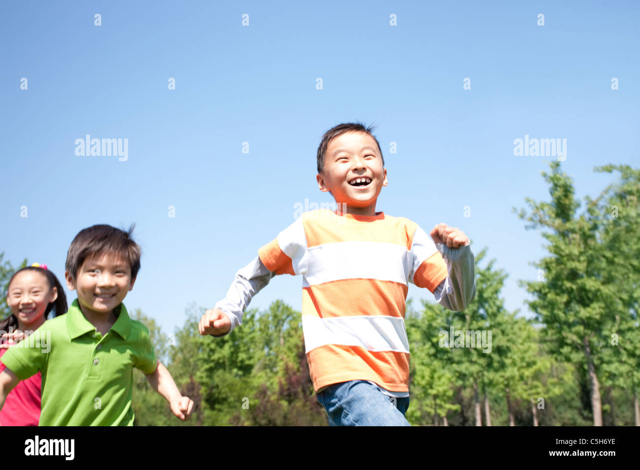 Children Running Across Field Stock Photo - Alamy