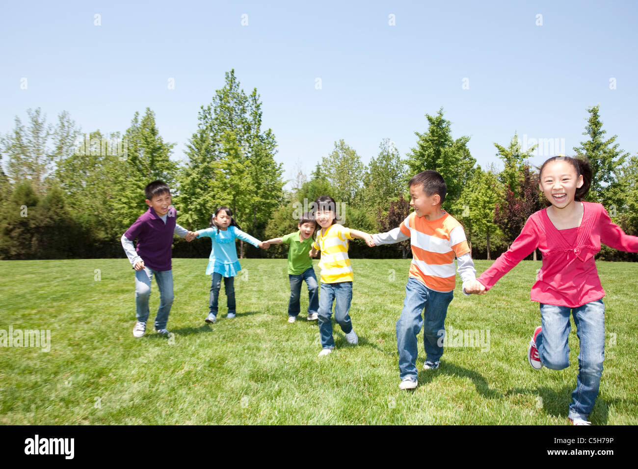 Young Children Playing in Field Stock Photo - Alamy