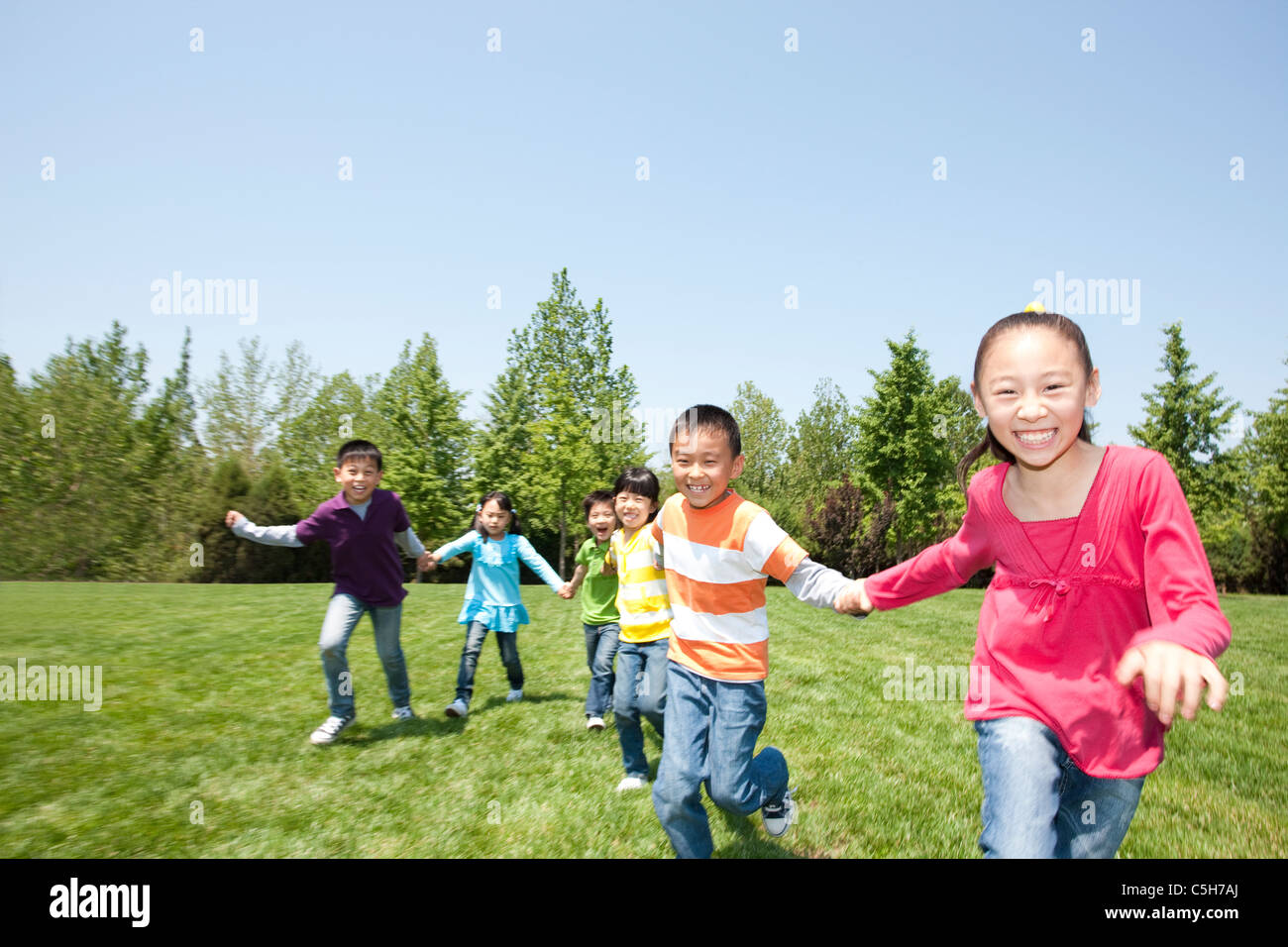 Young Children Playing in Field Stock Photo - Alamy