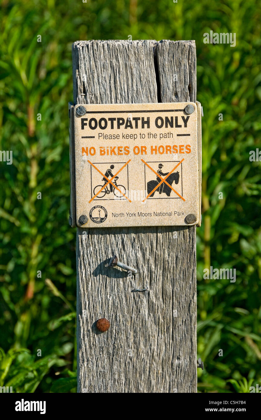 Close up of footpath public path only sign signage nailed to wooden ...