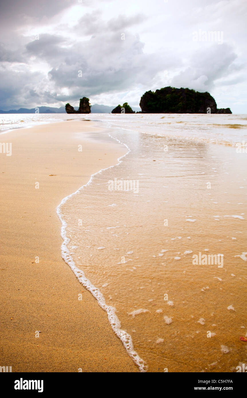Waves lap a sand bar with spectacular sunset colours Stock Photo - Alamy