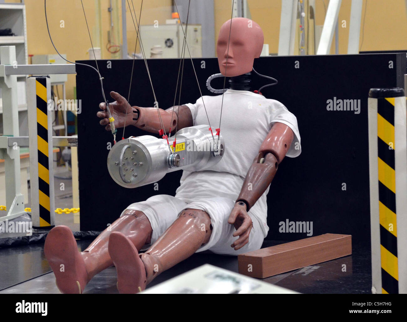 Various types of dummies for experiments stand by in their waiting room ...