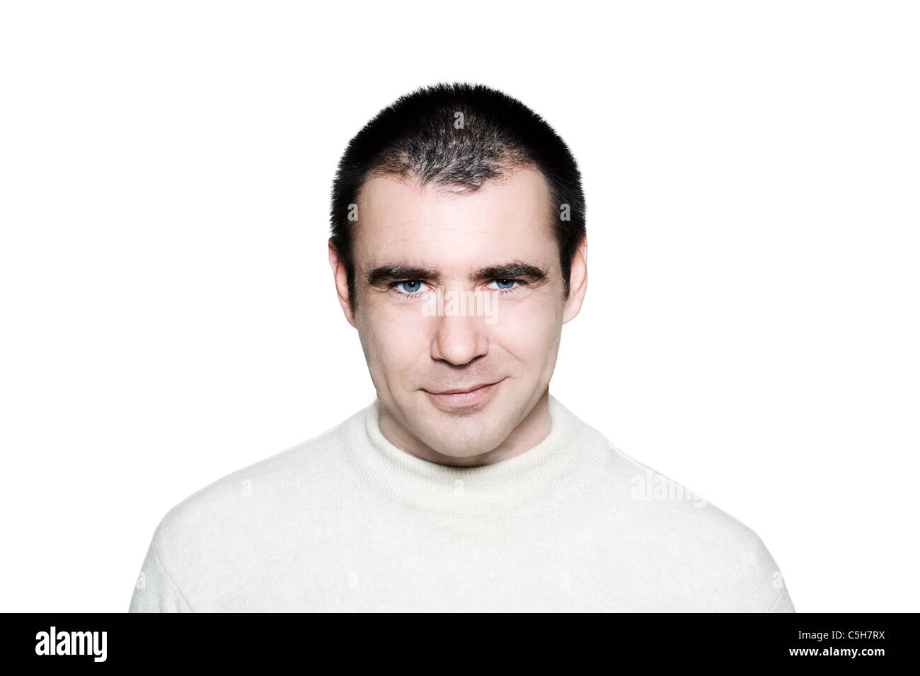 Portrait of a handsome expressive man smirking in studio on white ...