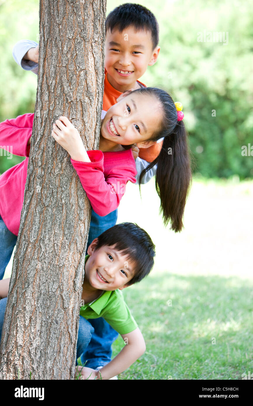 Portrait of children playing under a tree Stock Photo - Alamy