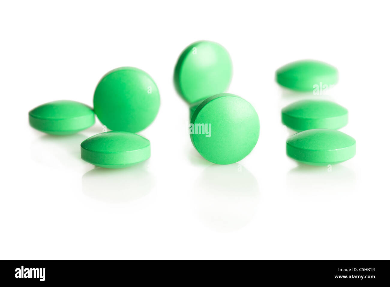 Group of green pills on white background Stock Photo - Alamy