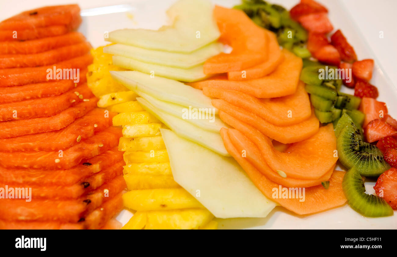 A selection of sliced tropical fruits on a platter Stock Photo - Alamy