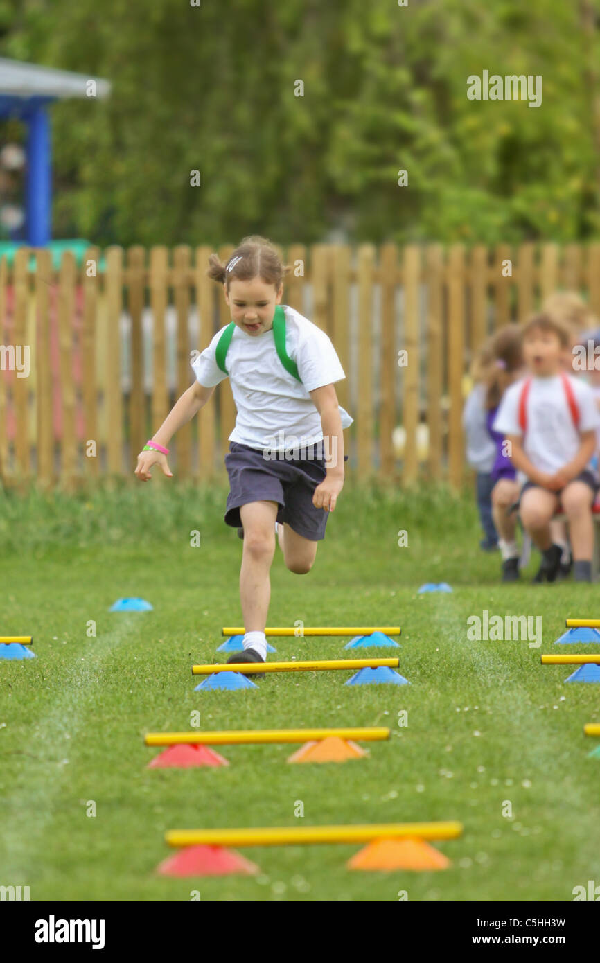 Young girl competing in running race on sportsday Stock Photo - Alamy