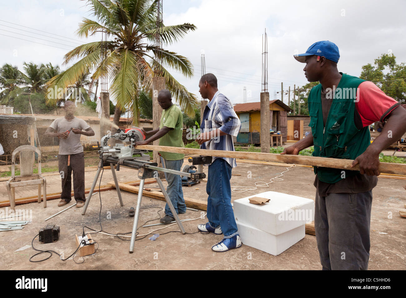 African workmen sawing timber on a building site. Accra, Ghana Stock ...