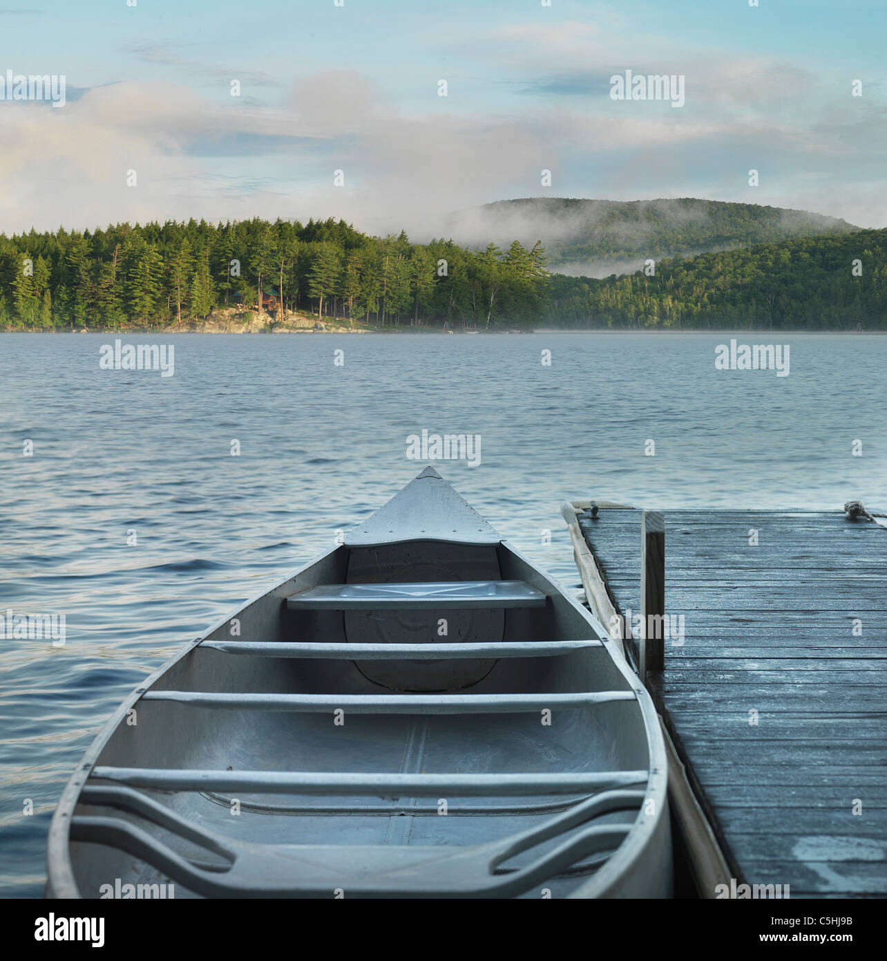 canoe by dock on Adirondack lake at sunrise Stock Photo - Alamy