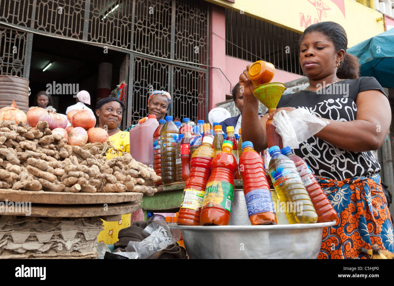 Market traders selling a range of fresh food produce and cooking ...