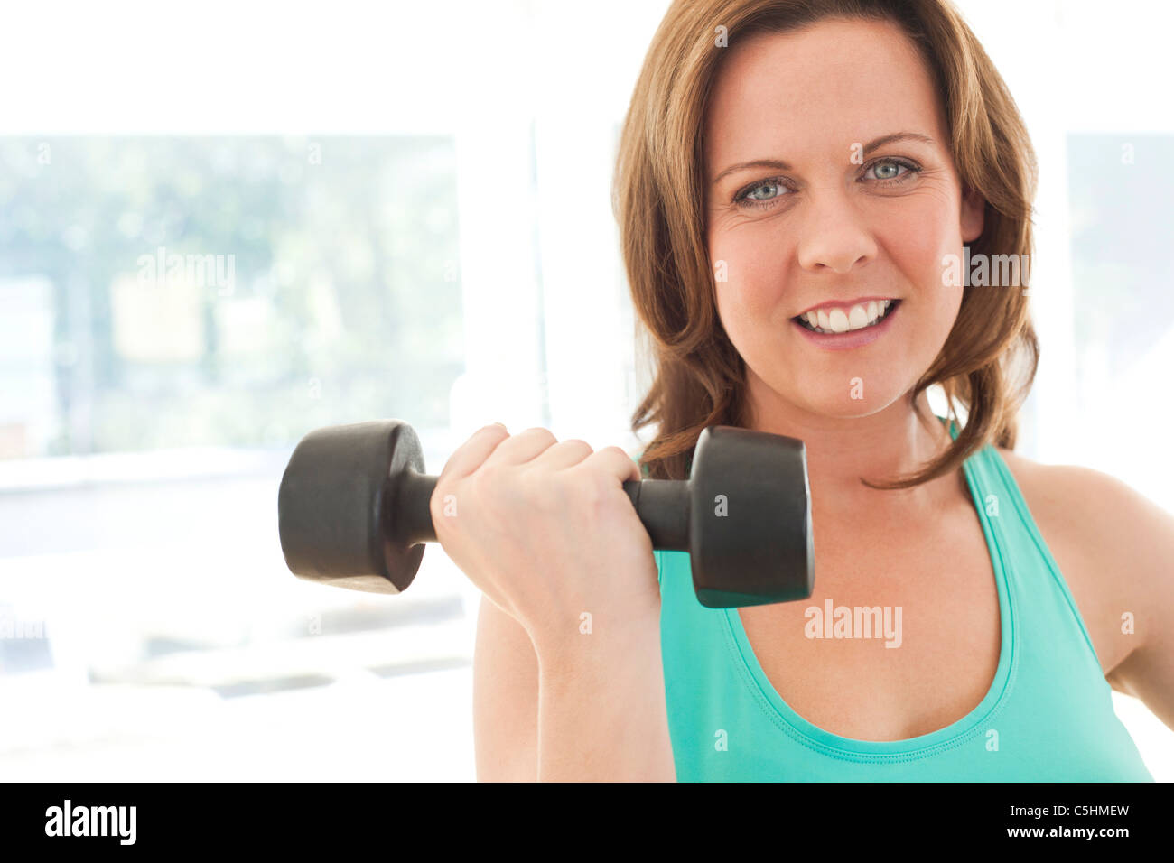 Woman lifting weights Stock Photo - Alamy