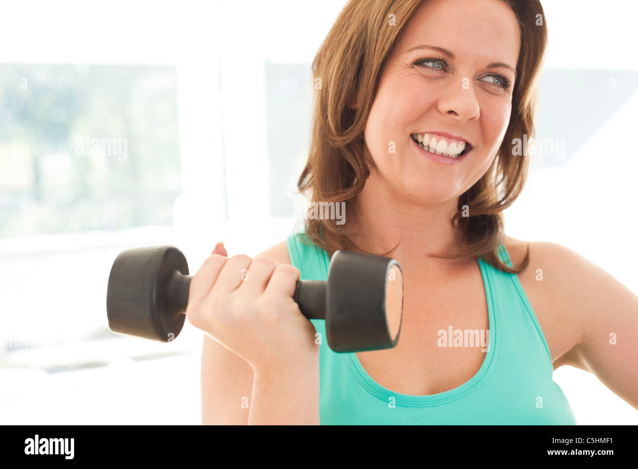 Woman lifting weights Stock Photo - Alamy