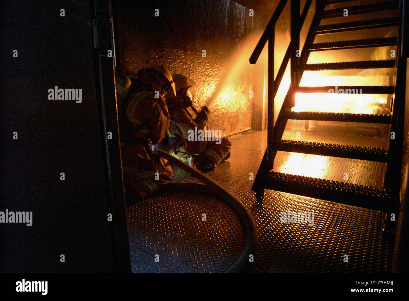 LIve fire training burn trailer is used to train firefighters in a simulated kitchen fire Stock ...
