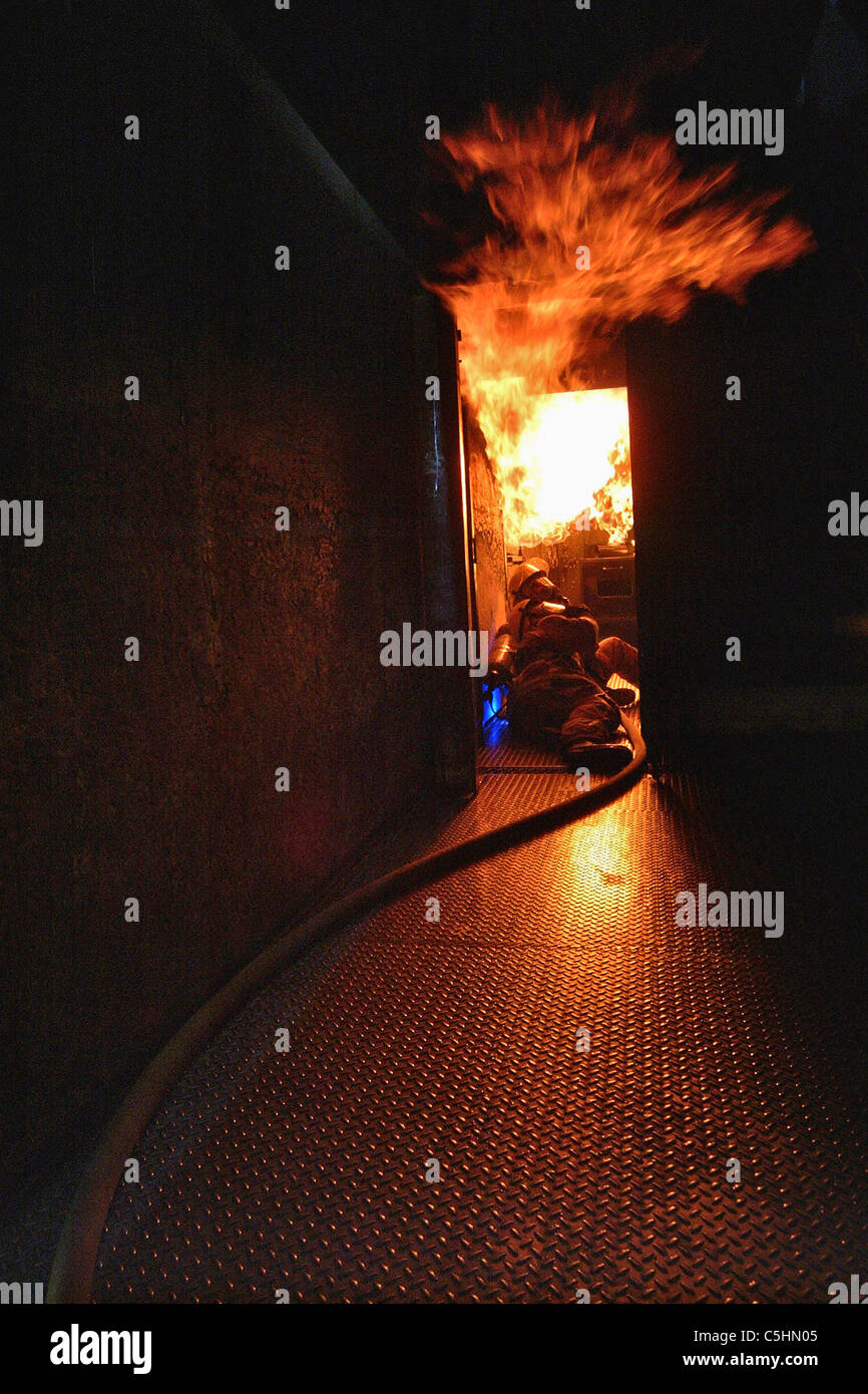 Firefighters attack a kitchen fire inside the fire training burn ...