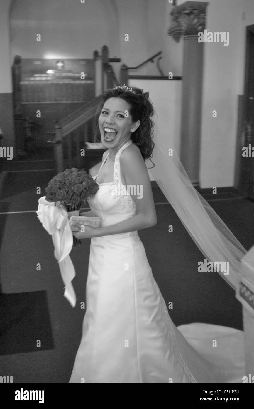 An excited bride shouts just as she walks down the aisle to get married ...