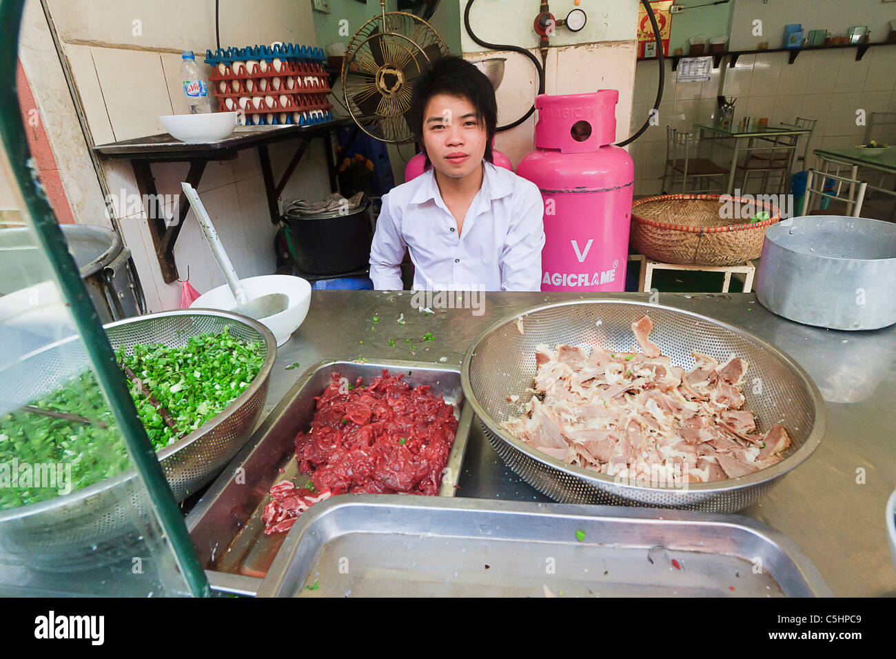 Man sells "pho," traditonal Vietnamese noodle soup, from stand on the ...