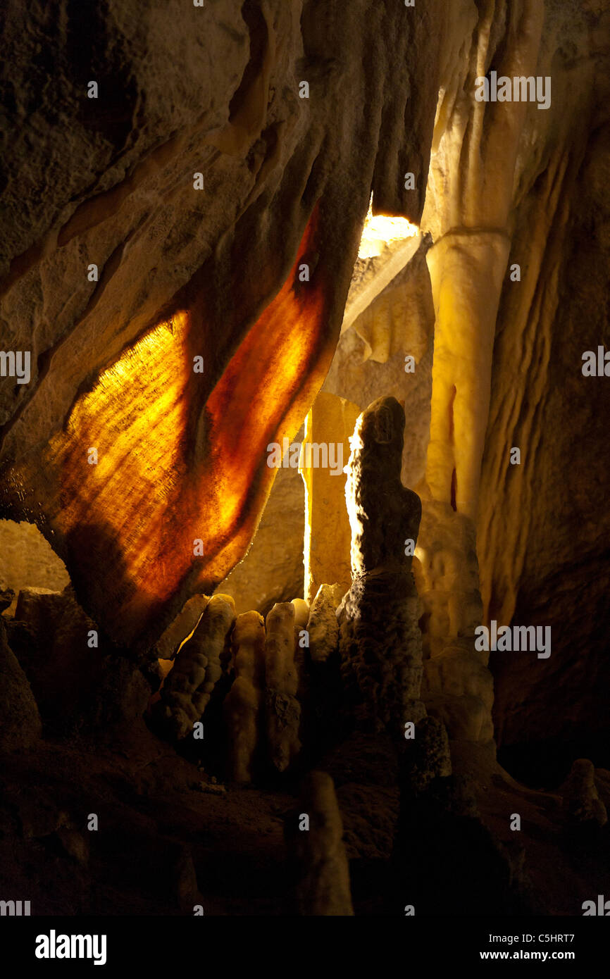 stalagmite curtain and stalactite in Postojna Cave. Backlit calsium ...