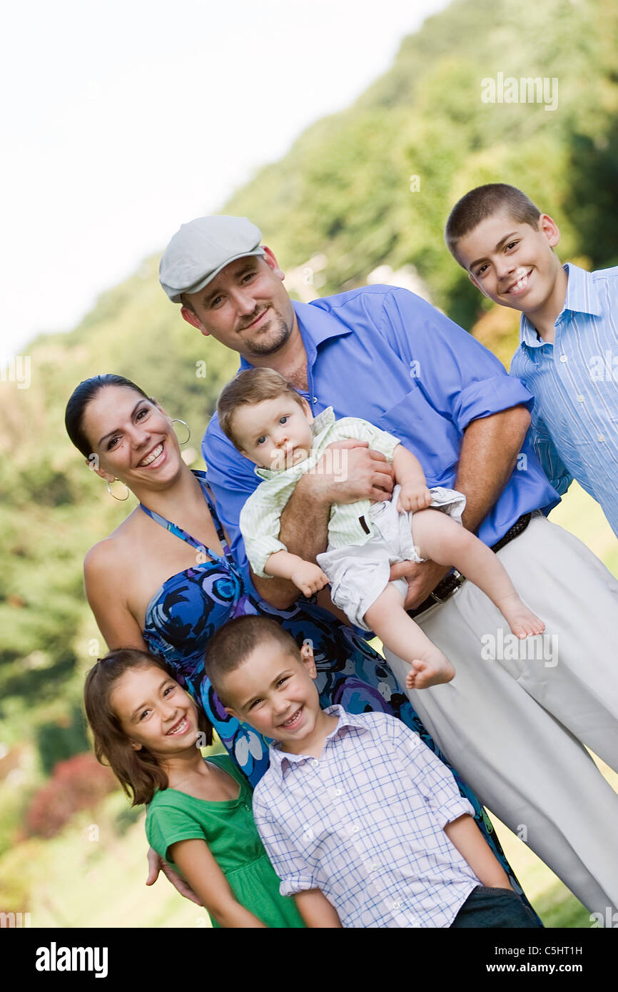 Portrait of an nice looking family with four children and one baby ...