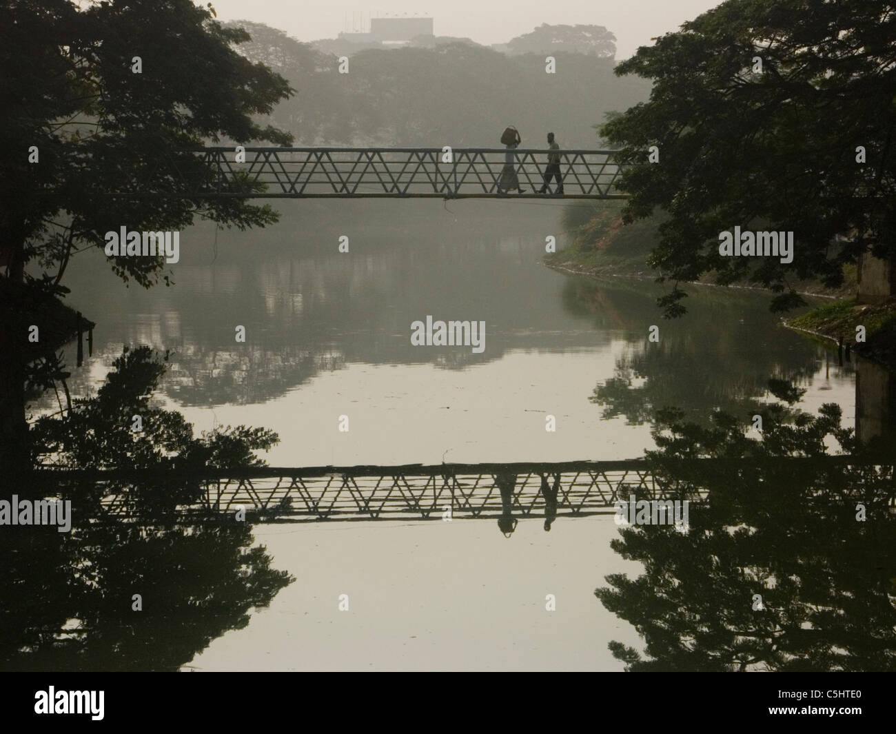 Pedestrians on a bridge in a park in the heart of Dacca, Bangladesh ...