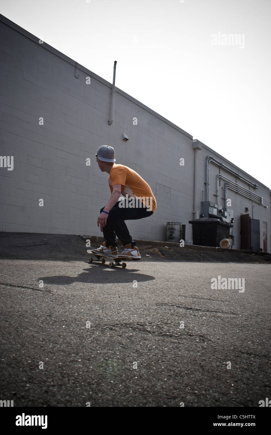 A young man skateboarding in an urban area Stock Photo - Alamy