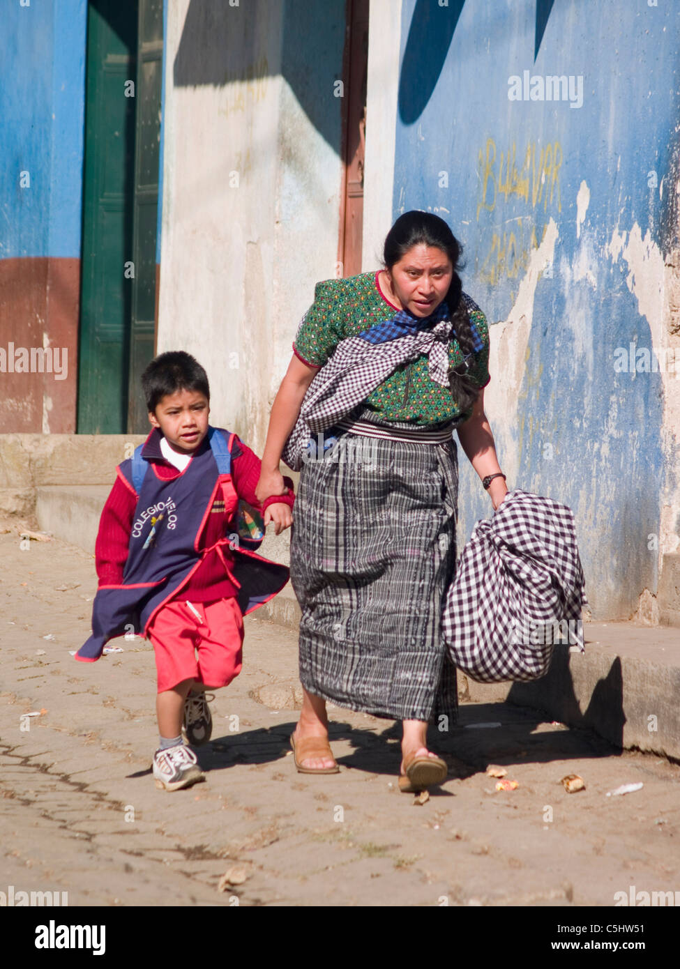 Woman and child hurry to school in Santa Maria de Jesus, Guatemala ...