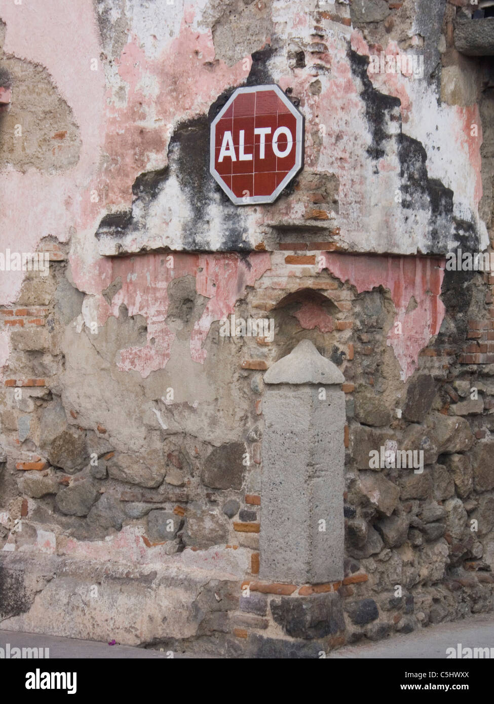 Aged building facades destroyed by weather, volcanoes and time, with ...