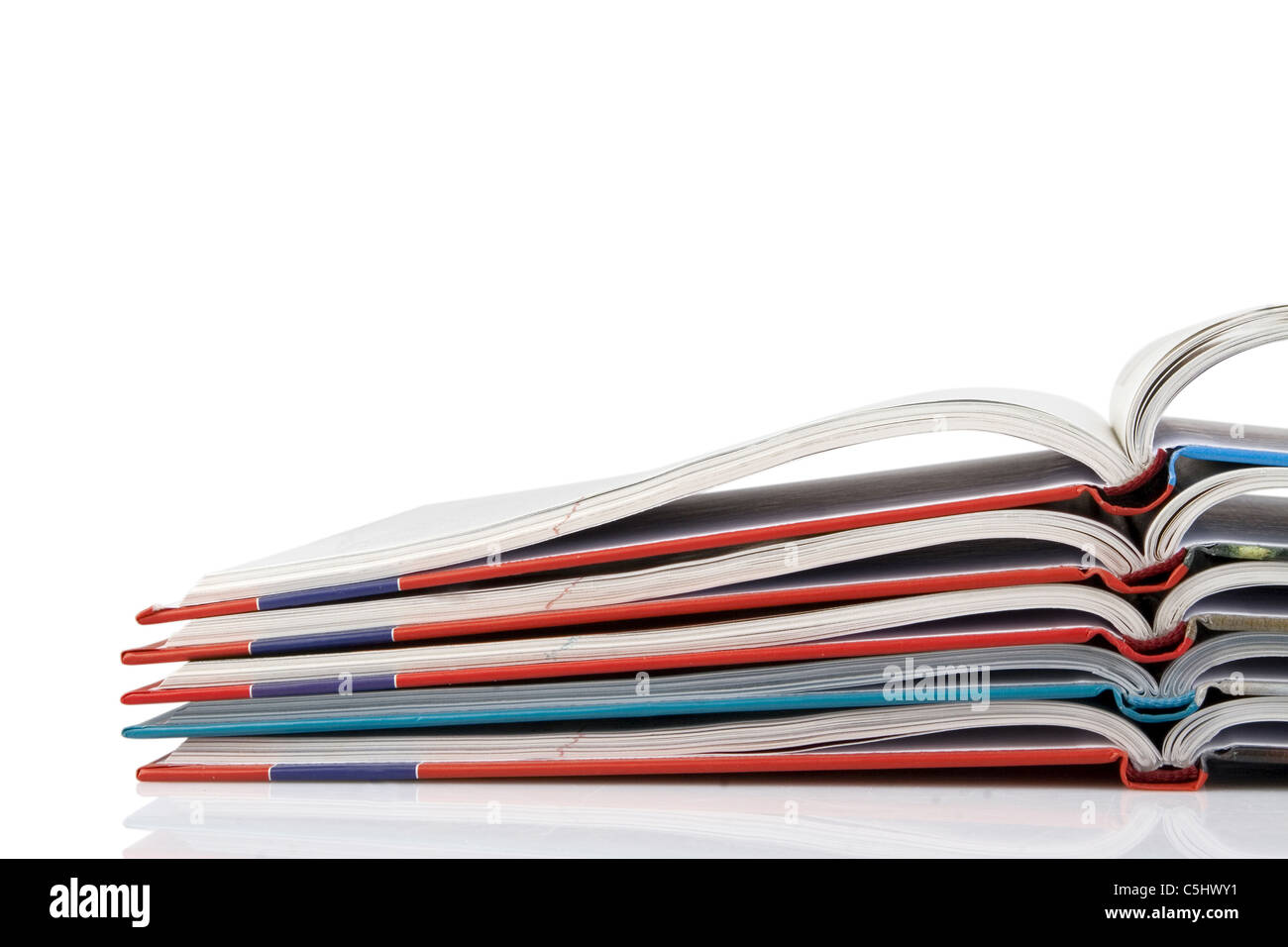 pile of new book with bending pages on white background Stock Photo - Alamy