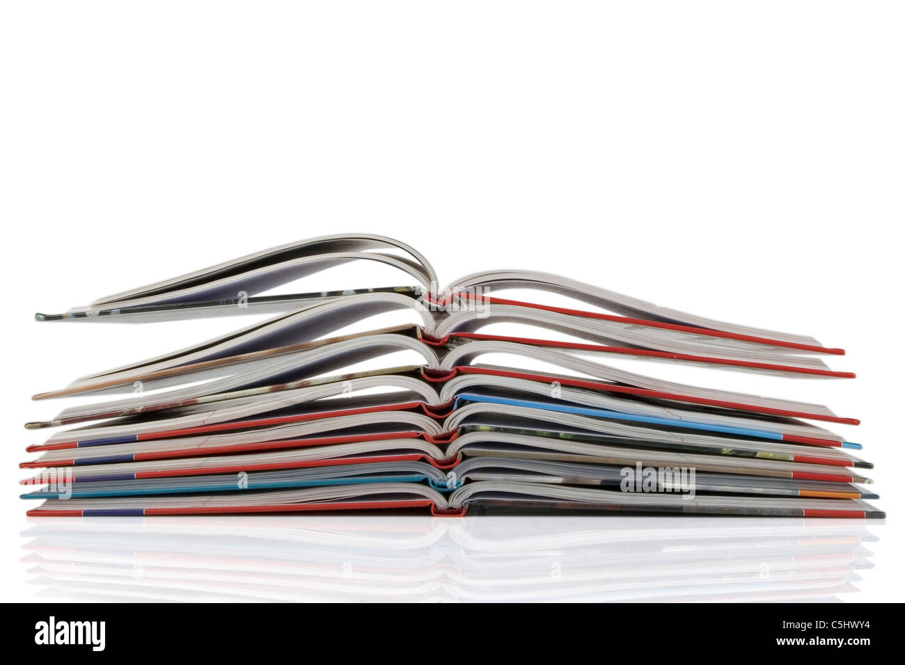 pile of new book with bending pages on white background Stock Photo - Alamy