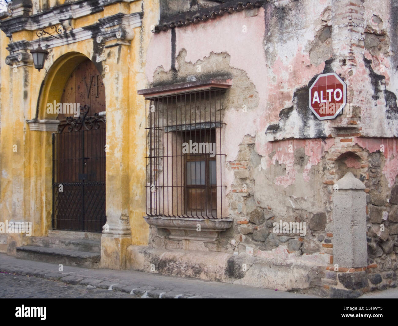 Aged building facades destroyed by weather, volcanoes and time, with ...
