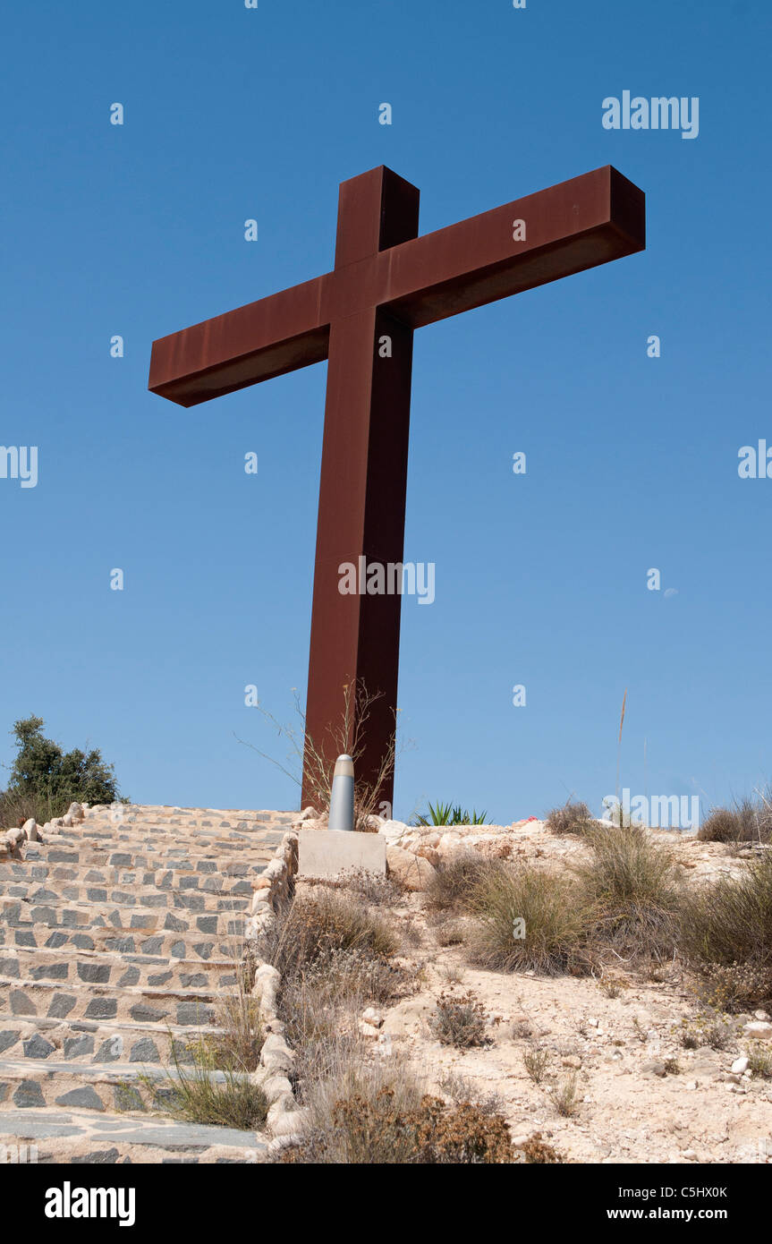 Large metal cross on a hill in the small Spanish town of Sucina in the ...