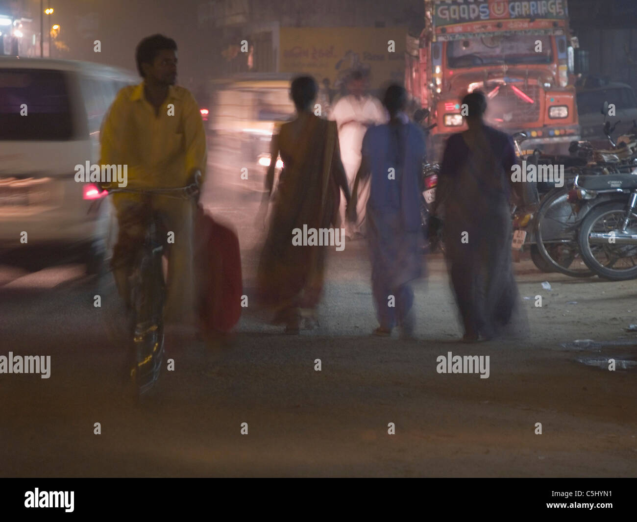 People walking at night on street of small town of Naroda, Gujarat ...