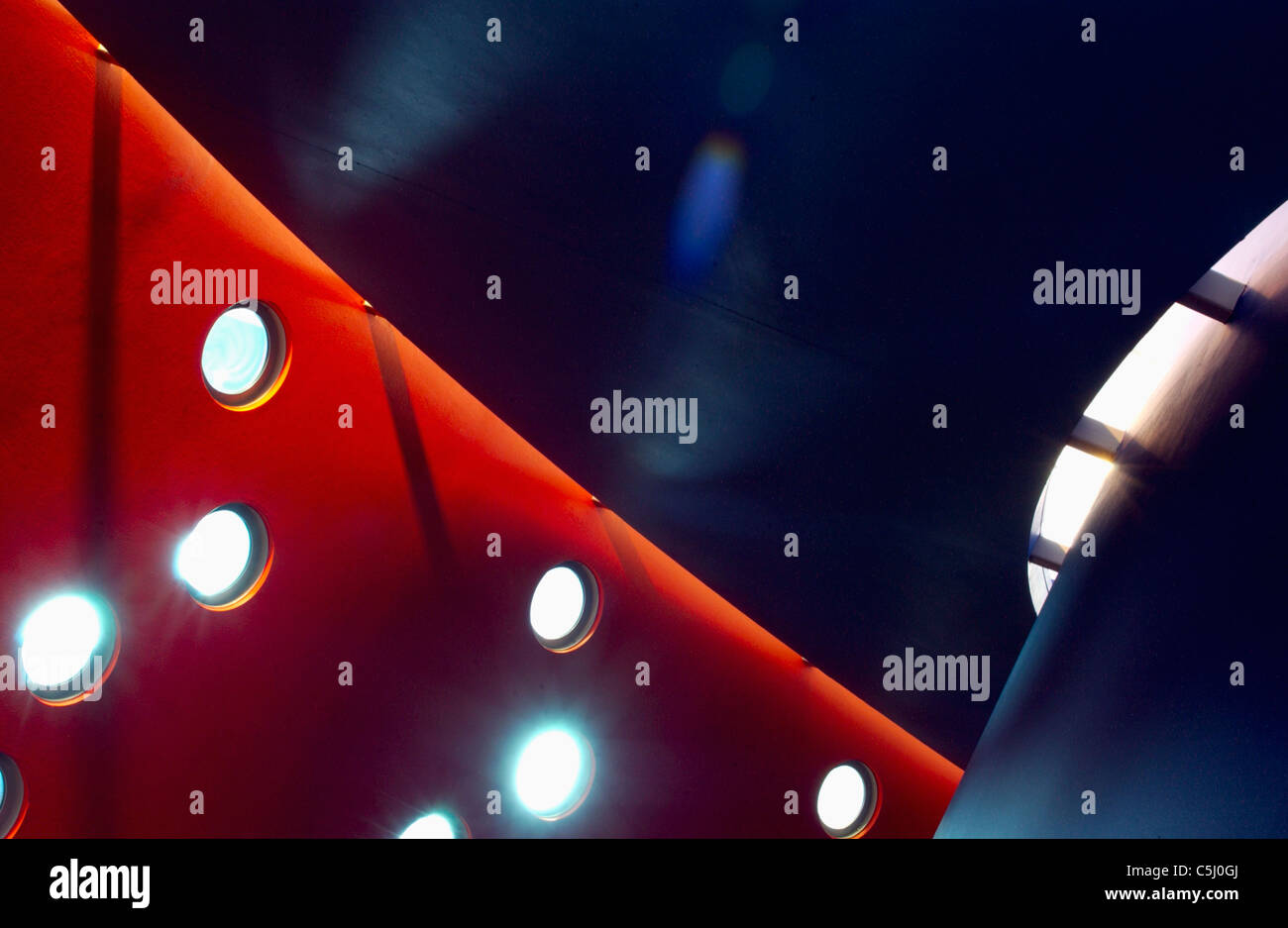 Orange screen with holes and lit from behind Stock Photo - Alamy