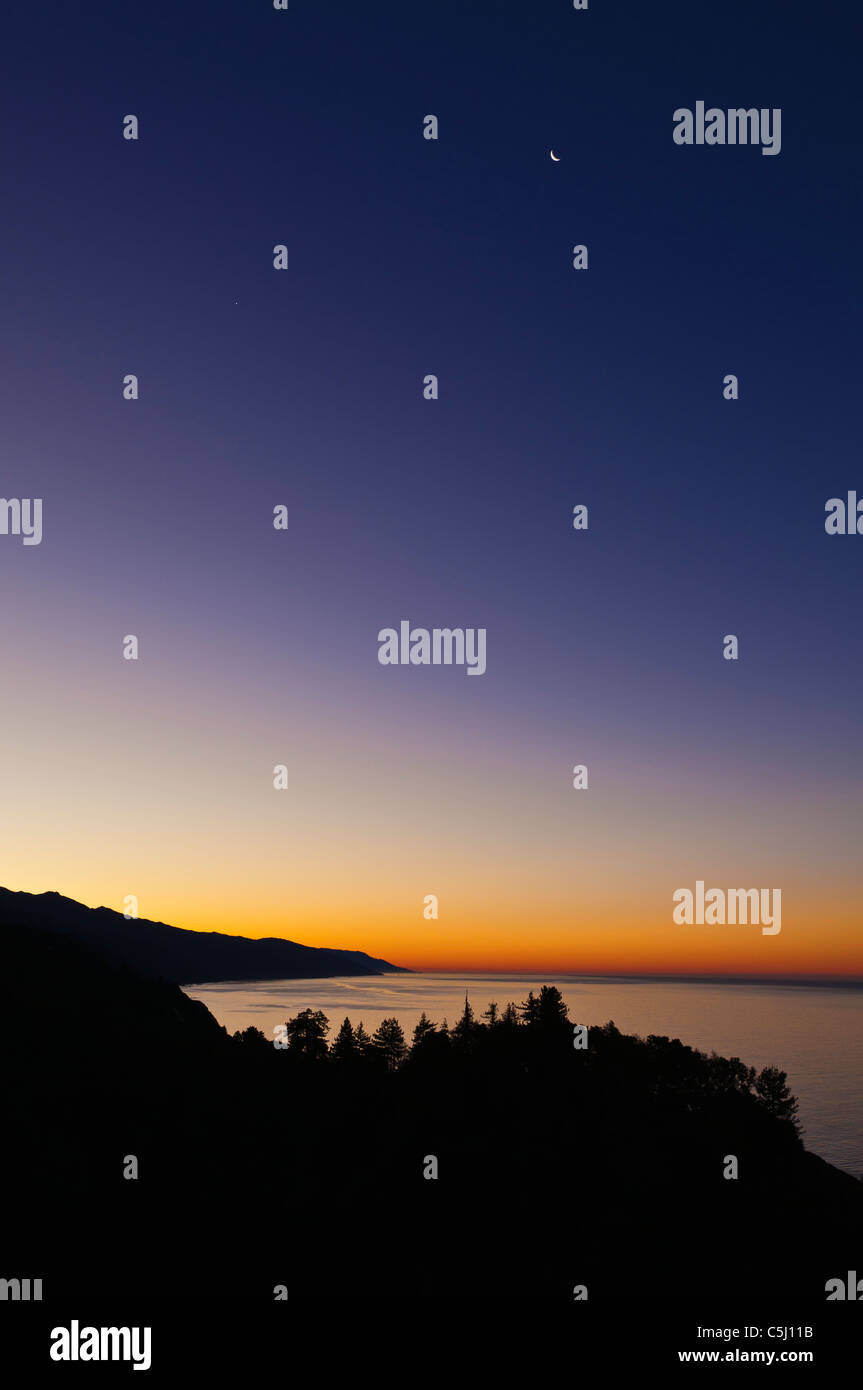 Crescent moon and dawn light over the Big Sur coast, California Stock ...