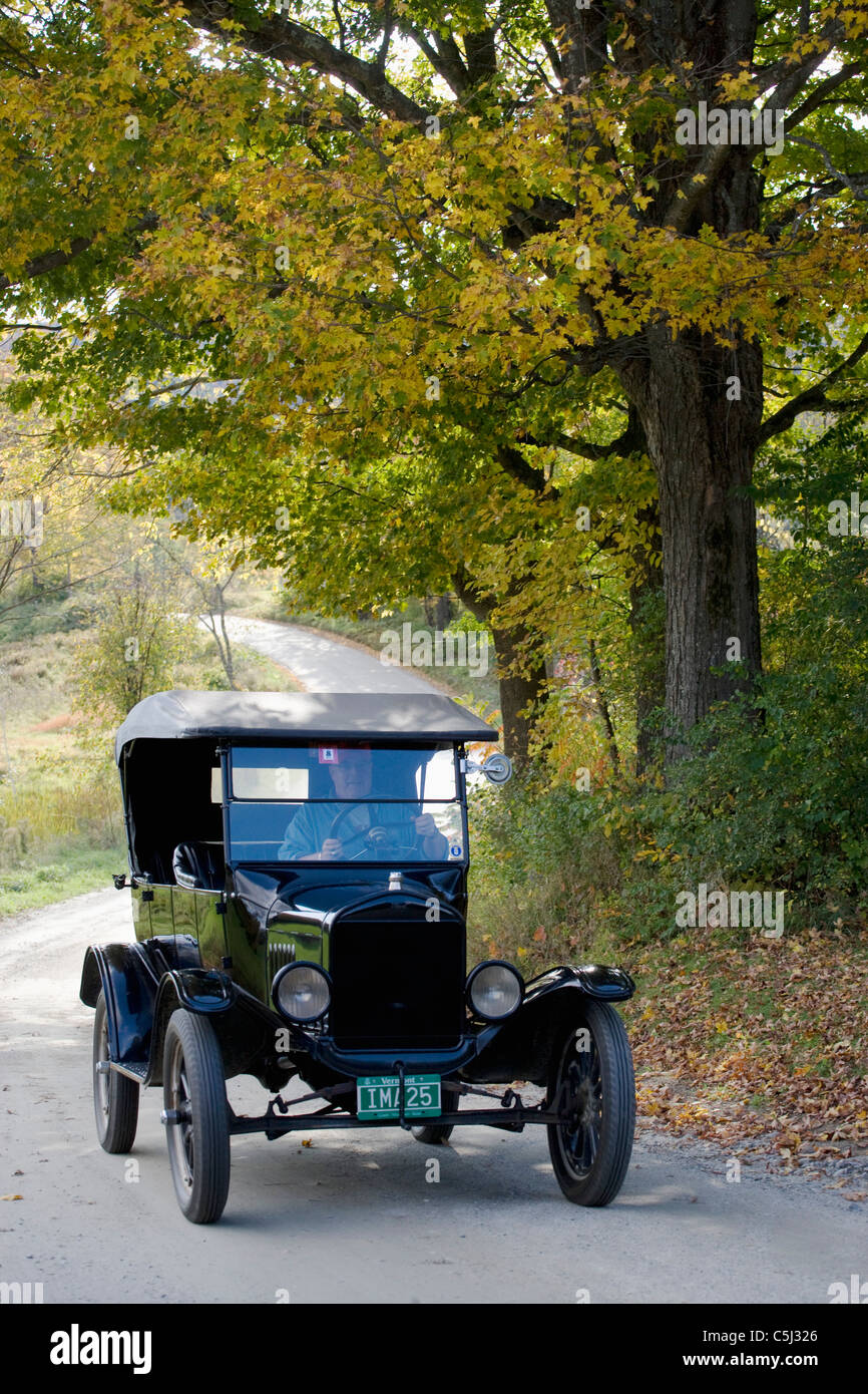 a man driving a Model T up a dirtroad Stock Photo - Alamy