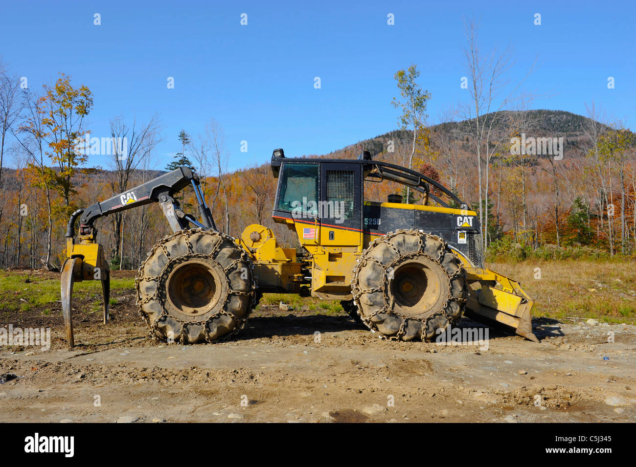 large logging hauler skidder sitting infront of trees Stock Photo - Alamy