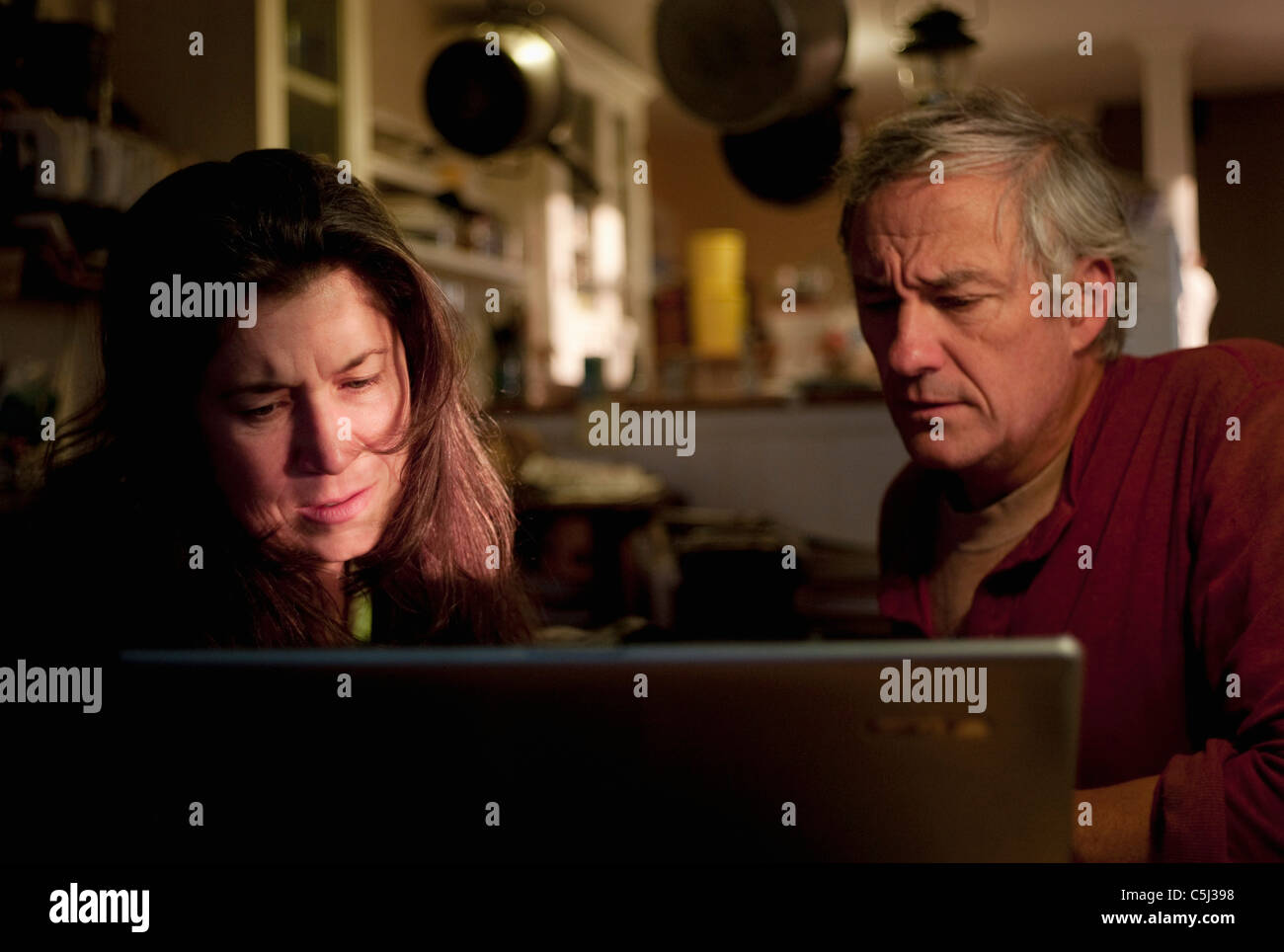man and woman looking at computer Stock Photo - Alamy