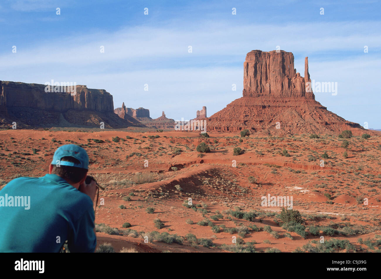 tourist taking a picture of desert cliffs Stock Photo - Alamy