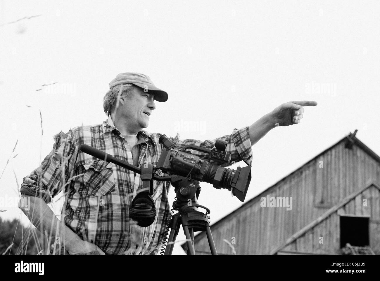 movie director standing and pointing behind video camera Stock Photo ...