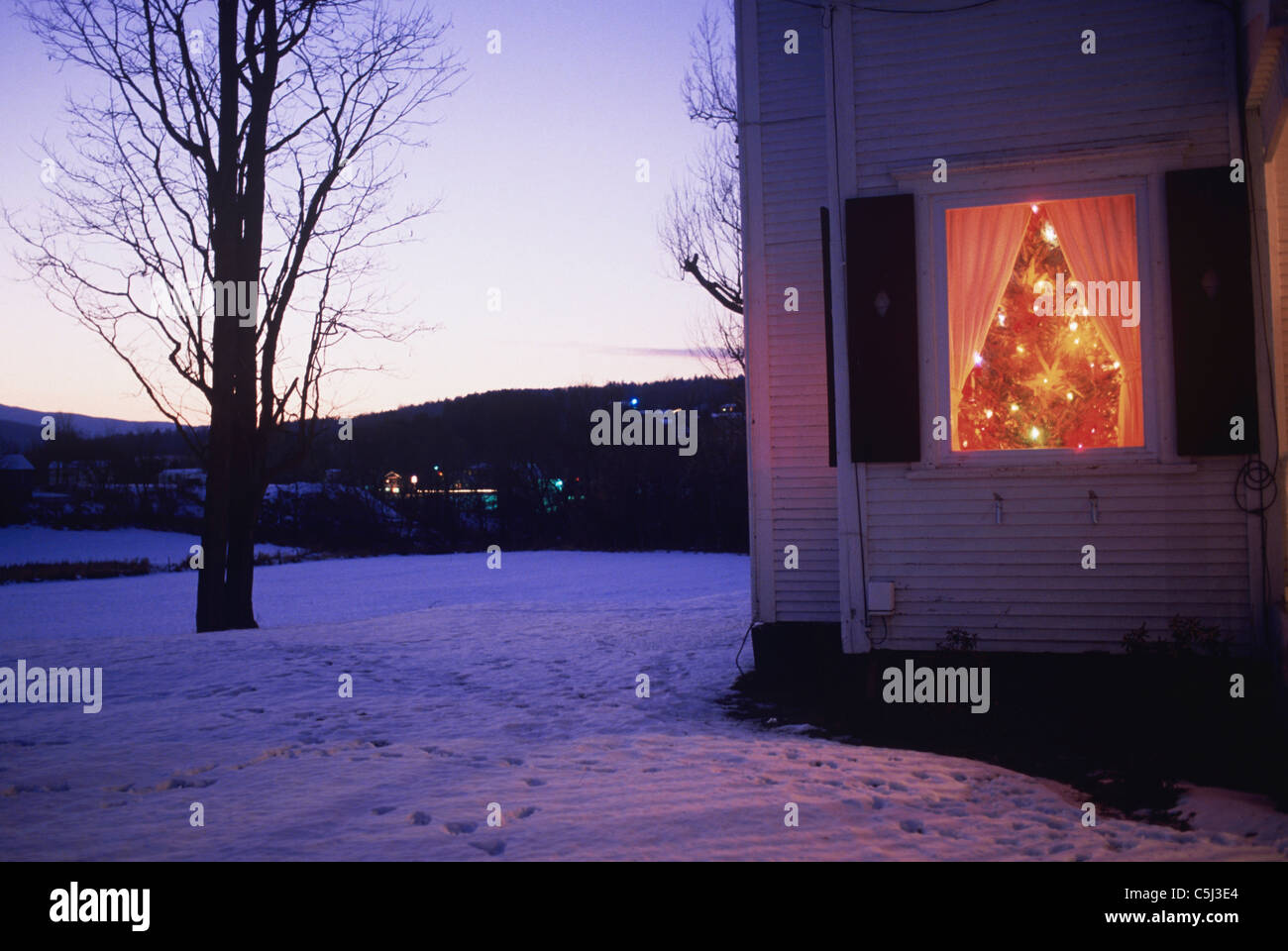 a Chrismas tree glows threw a window Stock Photo - Alamy