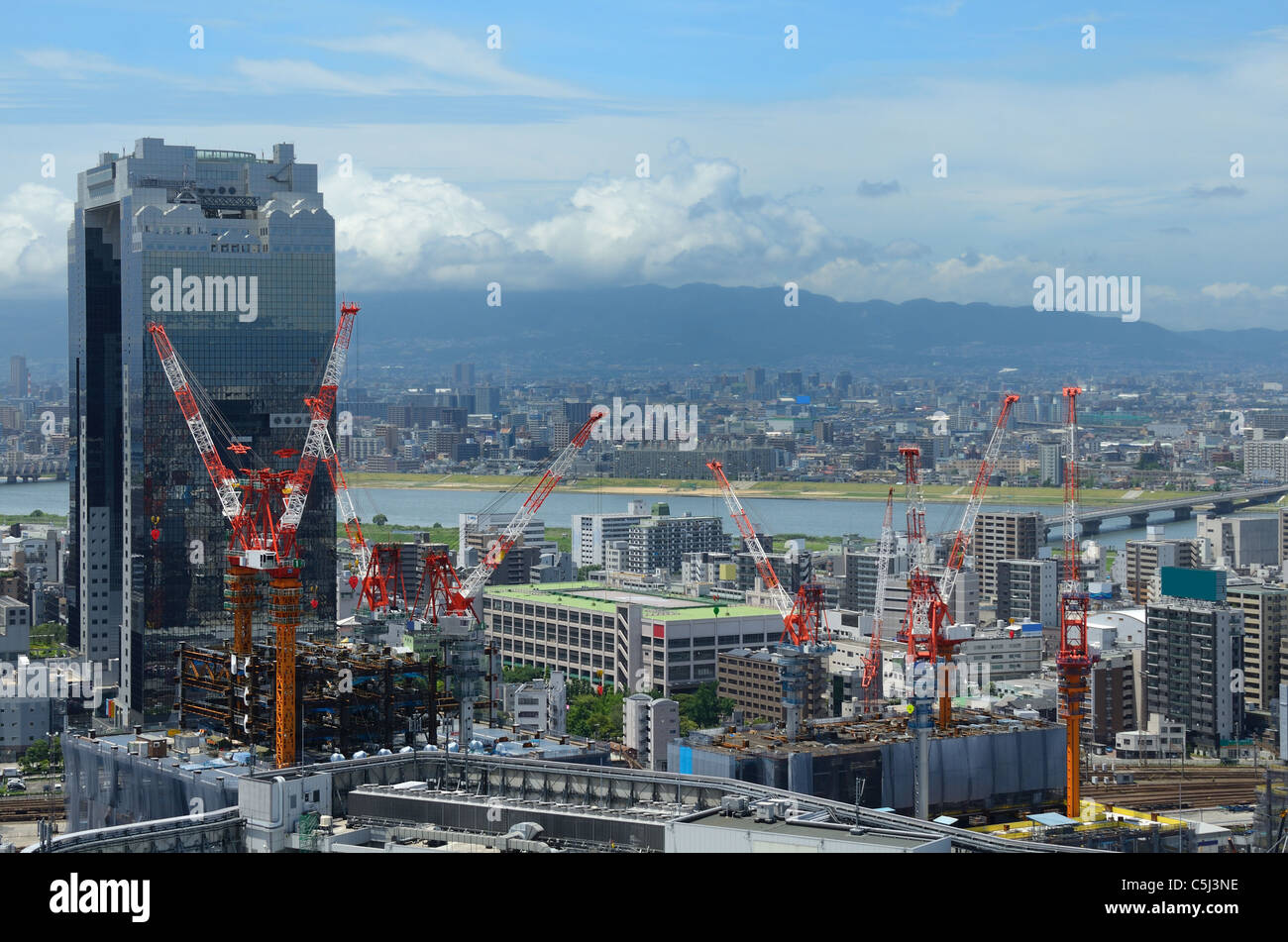 Osaka, Japan cityscape with Sky Building and construction cranes in ...