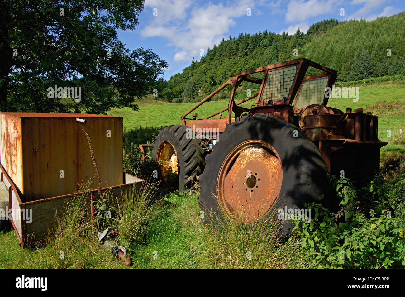 Ancient, abandoned tractor in a field-margin near Oban, Scotland, UK ...