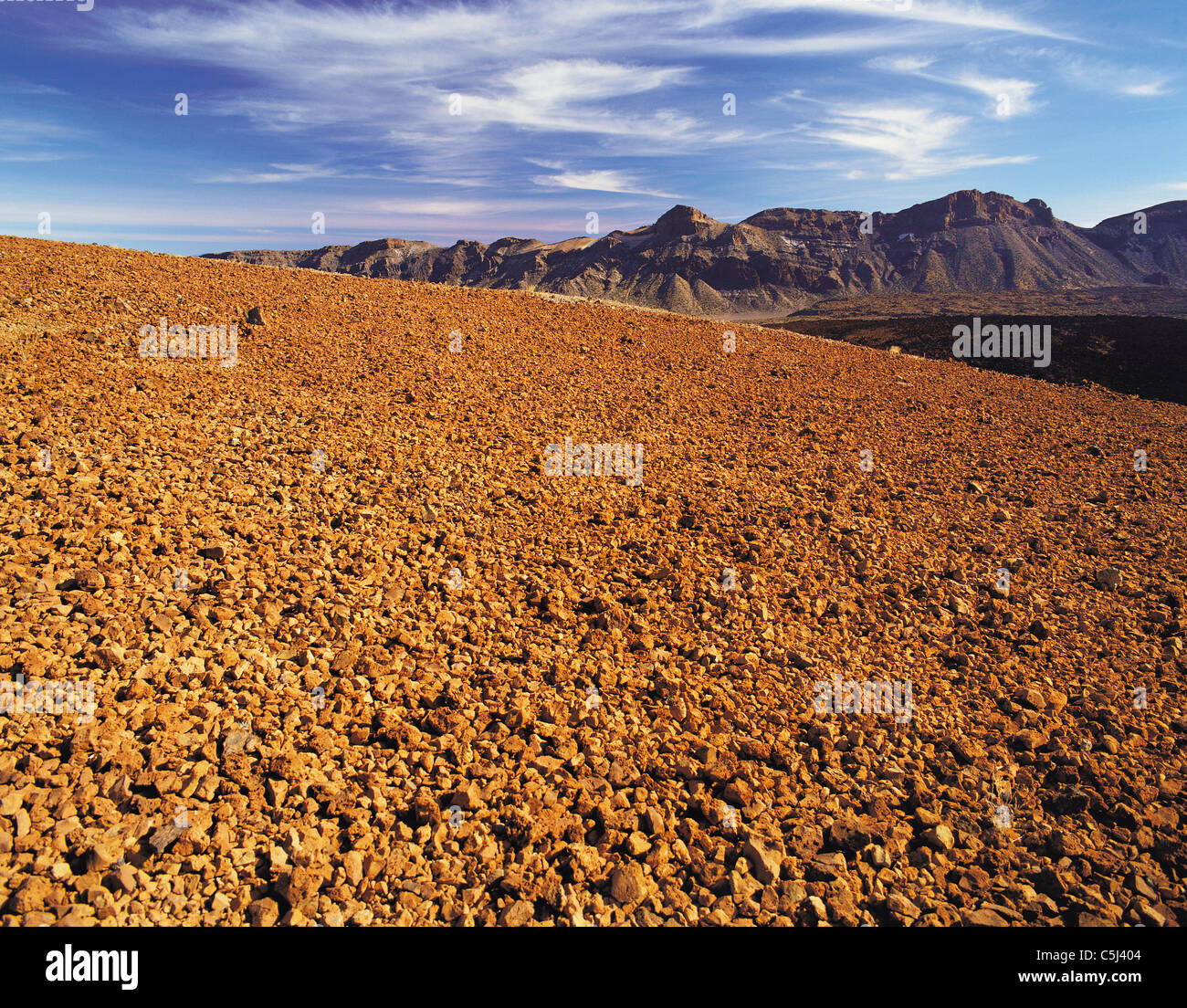 Stony desert area and distant dark mountain ridge in the Mt Teide ...