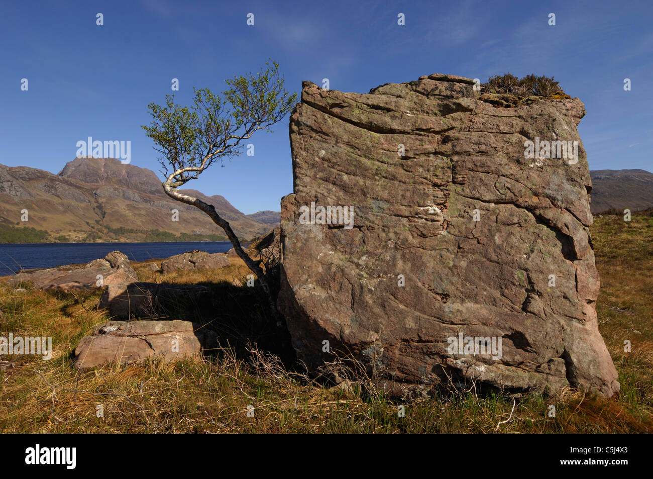 Big square boulder and distant mountain - Slioch, seen across Loch ...