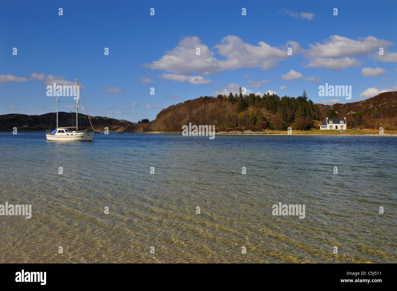 Yacht and cosy white cottage near the mouth of the River Morar, west ...