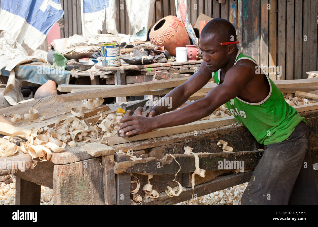 Carpenter planing timber to construct coffin, Accra, Ghana Stock Photo ...