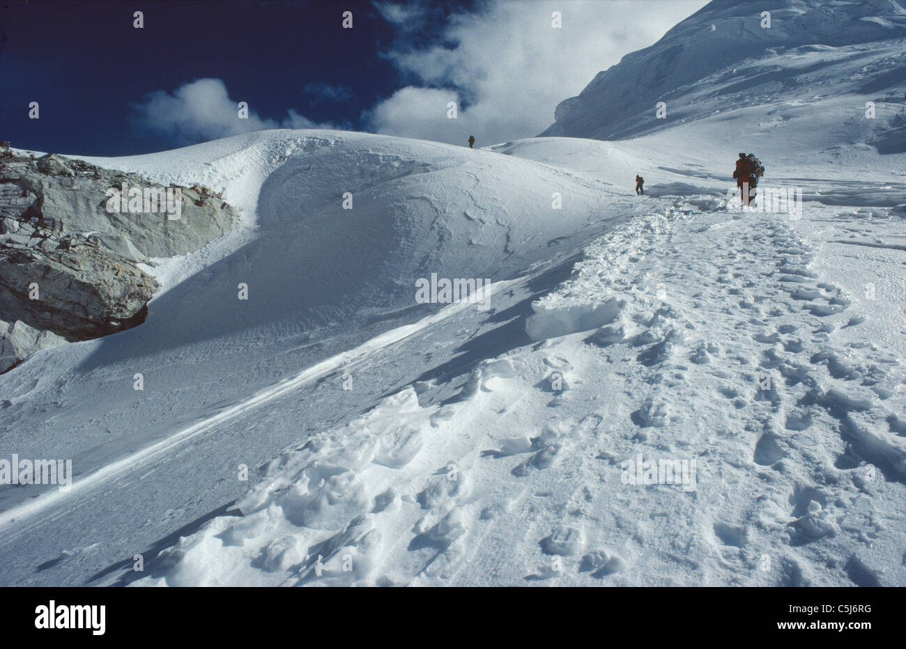 Climbers make their way up steep icy slopes towards the 19000-foot ...