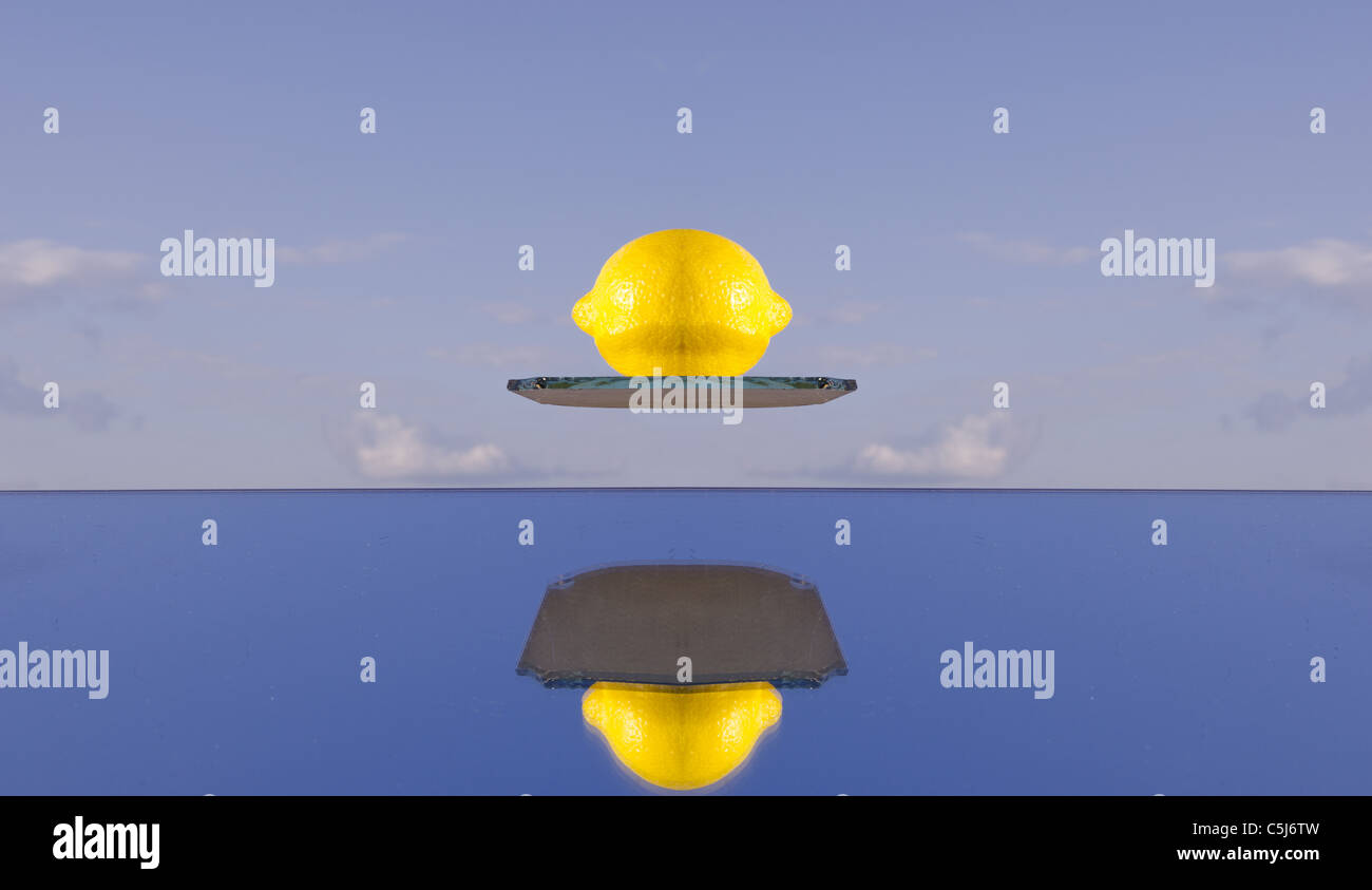 yellow lemon levitation on mirror collage - horizontal picture Stock ...