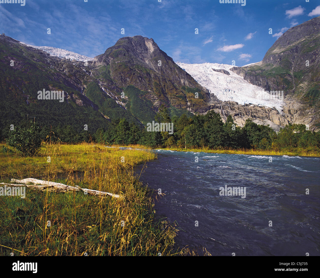 The Boyabreen Glacier falling steeply between two rocky peaks, and the ...